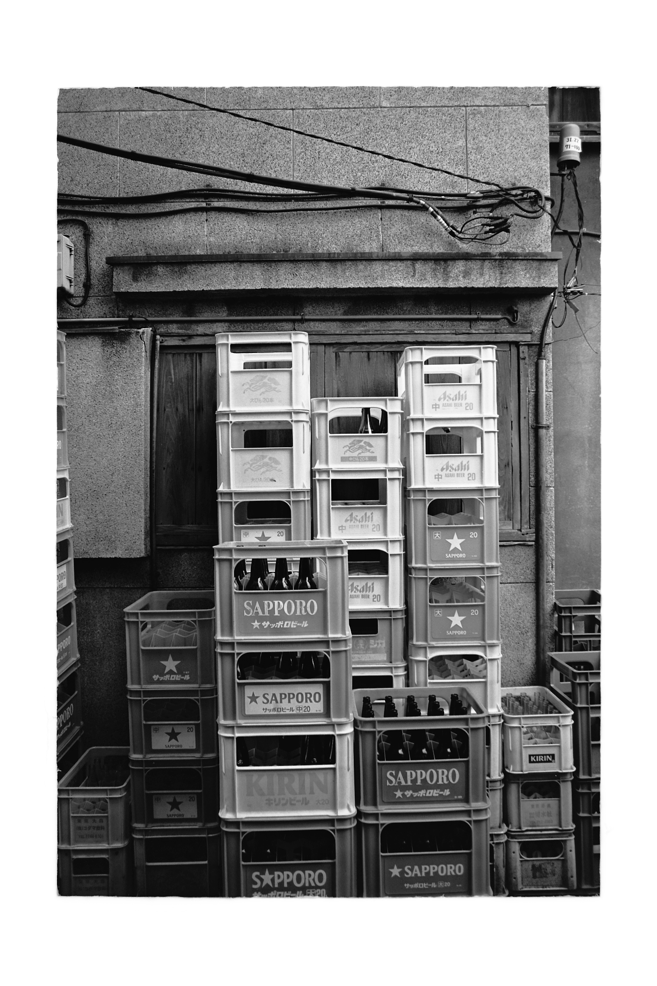 Tokyo Photography | Beer cases piled up in a narrow alley beside a ...