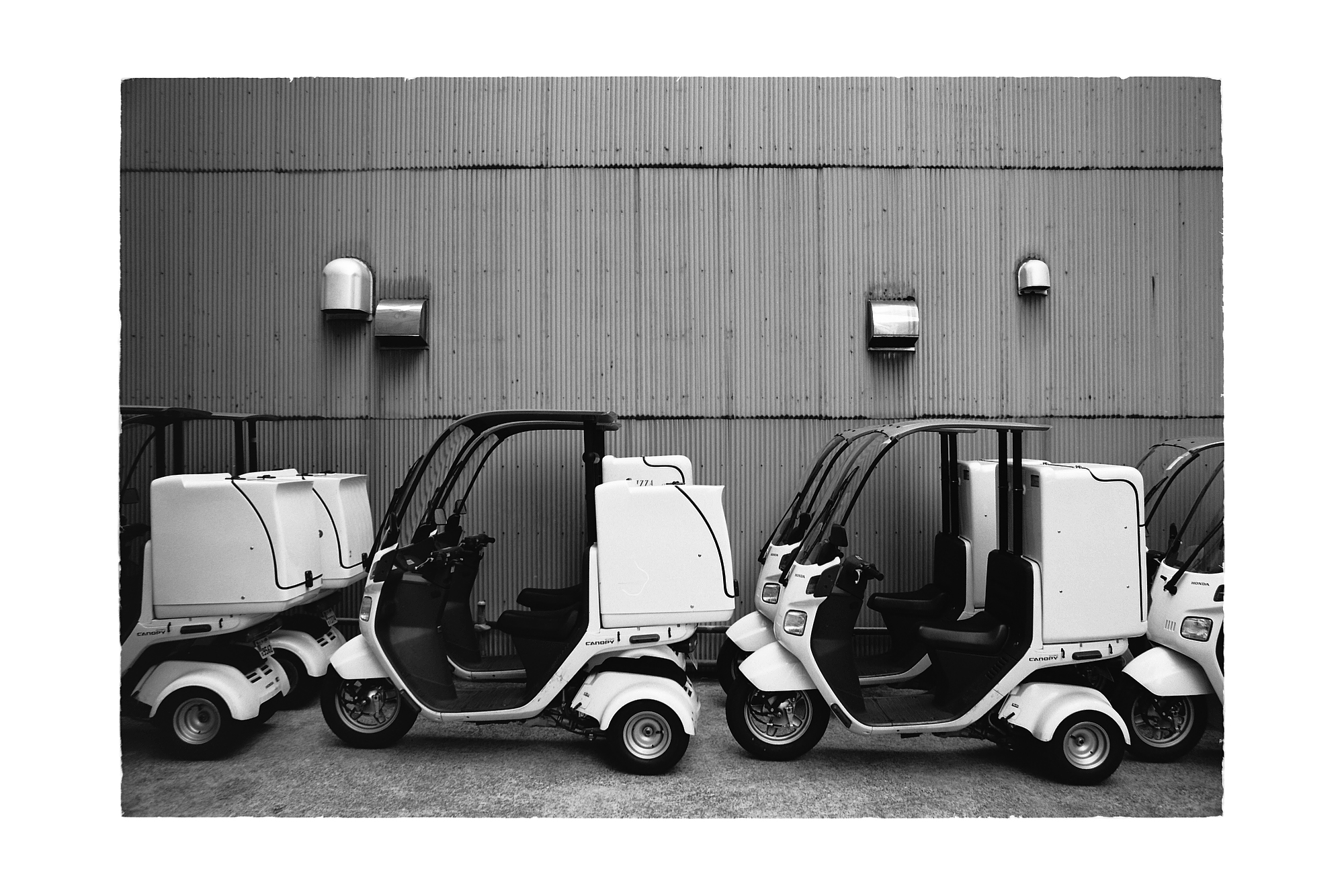 Tokyo Photography | Delivery bikes waiting beside the galvanized iron ...